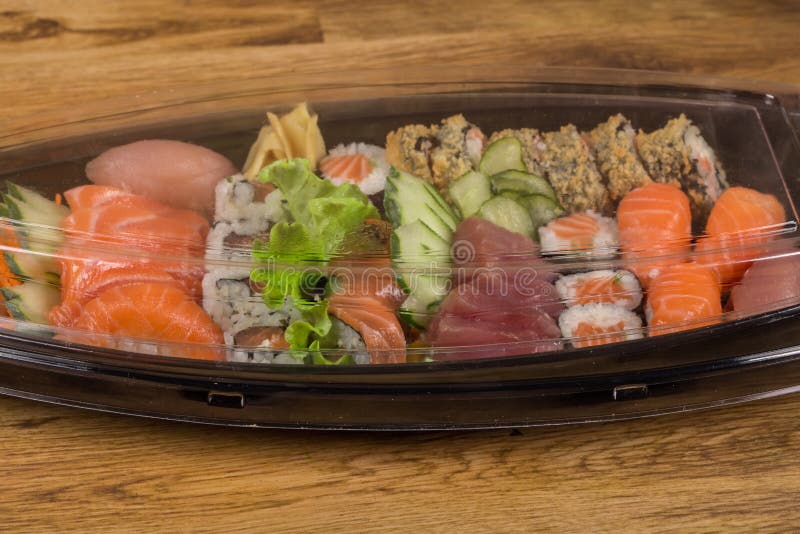 Set of Sushi Rolls in Plastic Box on Wooden Table. Sushi for Take Away ...