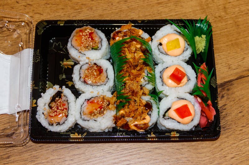 Set of Sushi Rolls in Plastic Box on Wooden Table. Sushi for Take Away ...