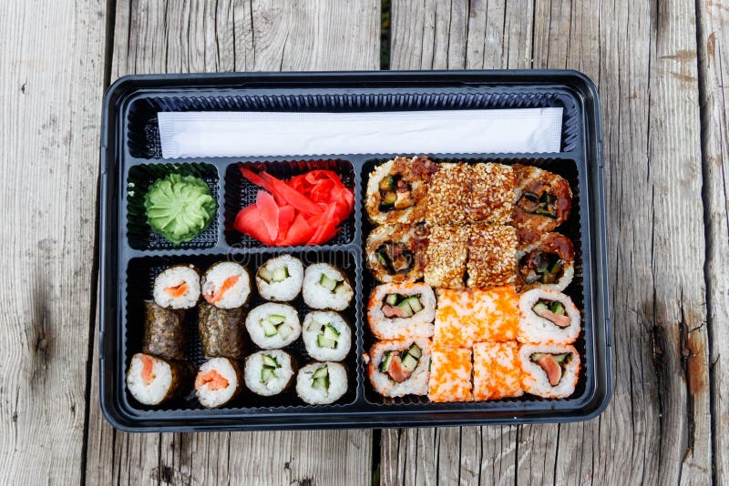 Set of Sushi Rolls in Plastic Box on Wooden Table. Sushi for Take Away ...