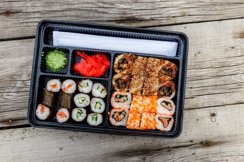 Set of Sushi Rolls in Plastic Box on Wooden Table. Sushi for Take Away ...