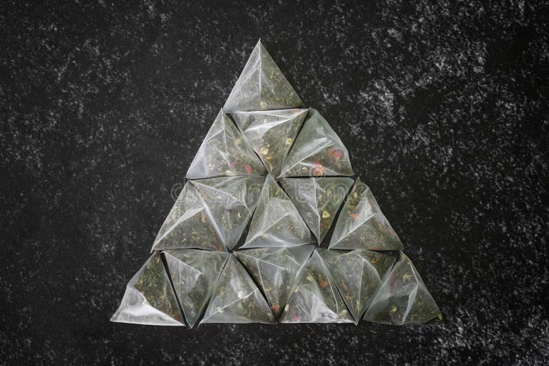 Set of Tea Bags-pyramids with Green Flavored Tea, on a Dark Textured ...