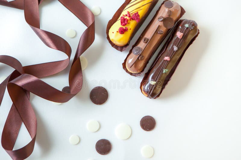 A Set of Three Eclairs with Different Fillings and Design Isolate on a ...