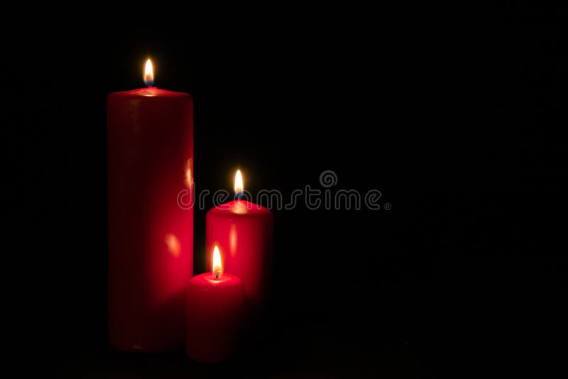 Set of Three Red Candles Burning in the Dark Stock Image - Image of ...