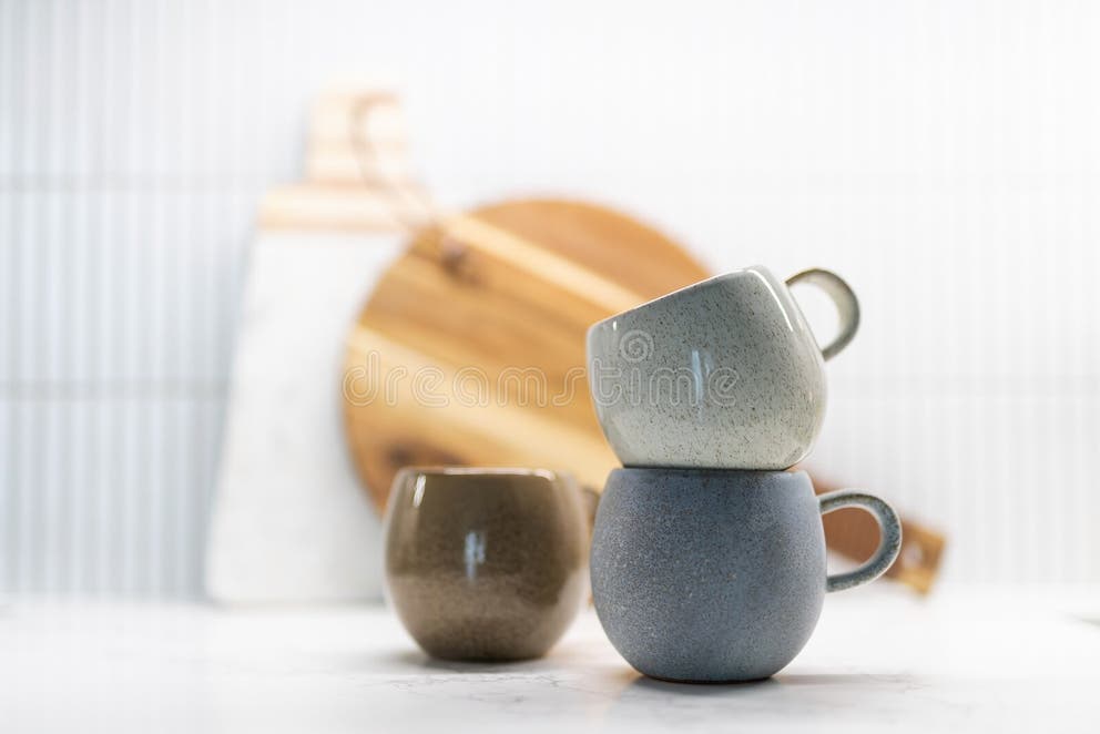 Set of Three Rustic Ceramic Mugs on Kitchen Counter. Stack of Handmade ...