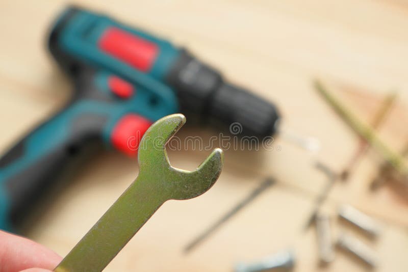 Set of Tools on Wooden Table, a Electric Screwdriver with a Set of ...