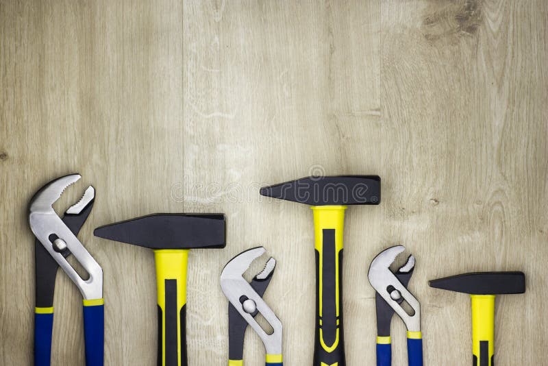 Set of Tools on a Wooden Table. Hammers and Wrenches. Plumbing Tools ...