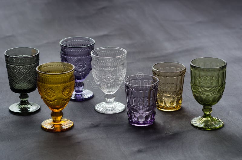 A Set of Transparent, Crystal Glasses of Different Colors, on a Dark ...