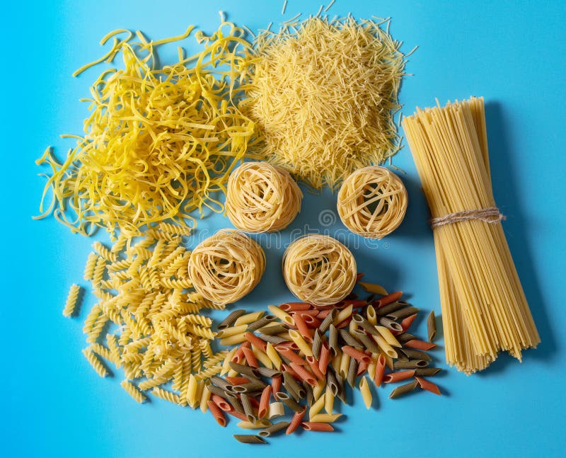 A Set of Various Pasta, Spaghetti on Blue Background Top View Stock ...