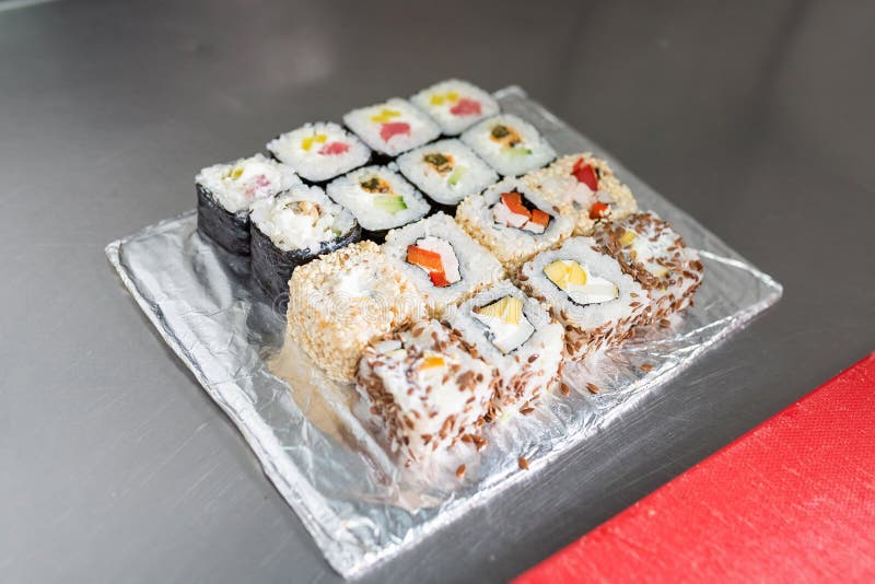 A Set of Various Sushi on a Sheet of Foil on the Kitchen Table Stock ...