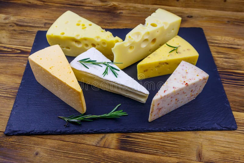 Set of Various Types of Cheese on Black Slate Board on Wooden Table ...