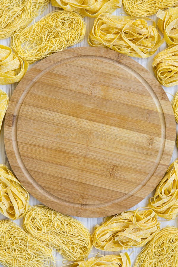 Set of Various Uncooked Pasta with Bamboo Board in the Center on Stock ...