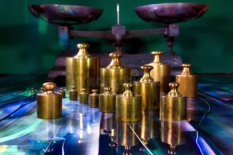 A Set of Vintage Balance Weights on a Reflective Coloured Surface ...