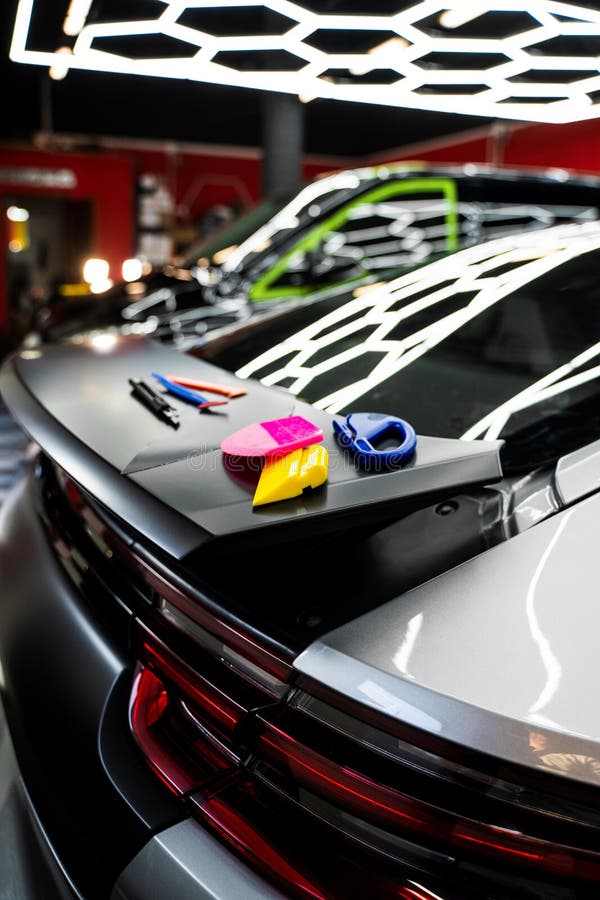 Set of Vinyl Wrapping Tools on the Car. Blades, Scrapers, and Squeegees ...