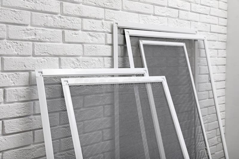 Set of Window Screens Near White Brick Wall Stock Photo - Image of ...
