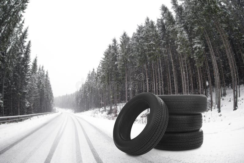 Set of Winter Tires on Forest Highway during Snowfall, Space for Text ...
