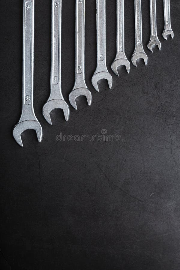 A Set of Wrenches on a Textured Black Background in a Row. Stock Image ...