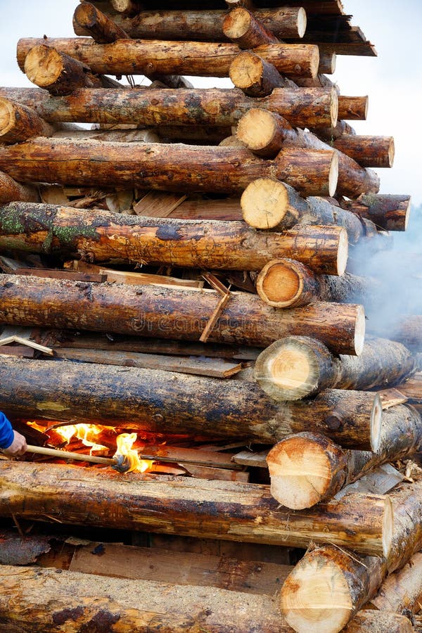 Setting Big Bonfire Made of Logs on Fire with Torch. Stock Image ...