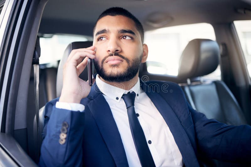 Setting His Goals in Motion. a Young Businessman Talking on a Cellphone ...
