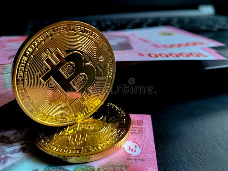 A Close-up of a Golden Bitcoin Token and Banknotes Stock Photo - Image ...