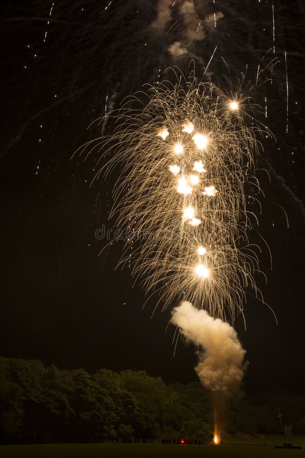 Setting Off Fireworks at Night: Up in a Puff of Smoke Stock Photo ...