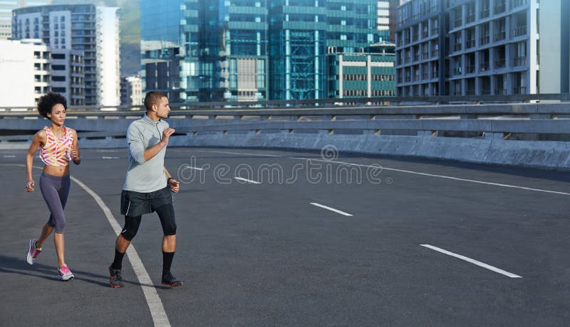 Setting the Pace. Two Friends Jogging Together through the City Streets ...