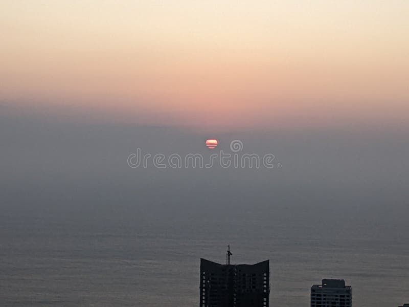Setting sun above building stock image. Image of build - 265658309