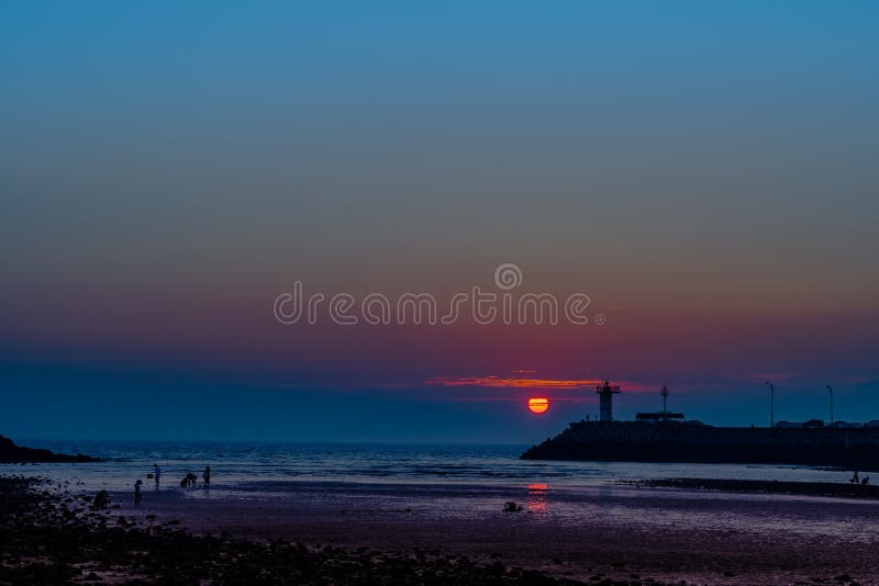 Setting Sun Behind Lighthouse Stock Photo - Image of coast, casting ...