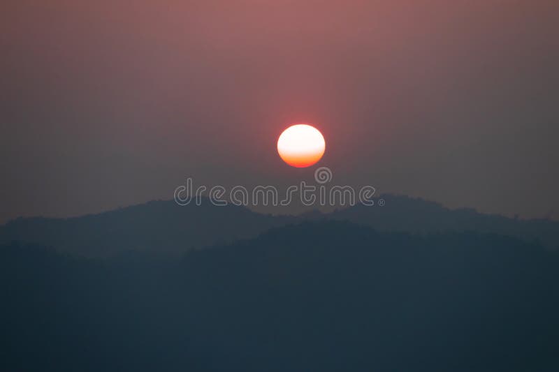 The Setting Sun Casts a Pink and Purple Glow on the Mountain Range ...