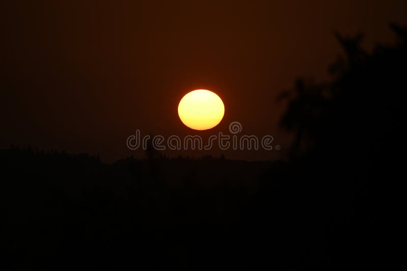 Setting Sun Dominates the Twilight Landscape, Casting Dramatic Shadows ...