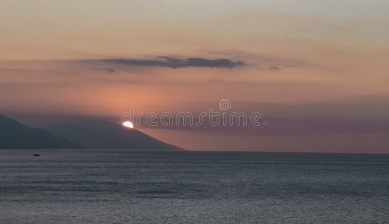 The Setting Sun is Half Hidden Behind the Mountain! Stock Image - Image ...