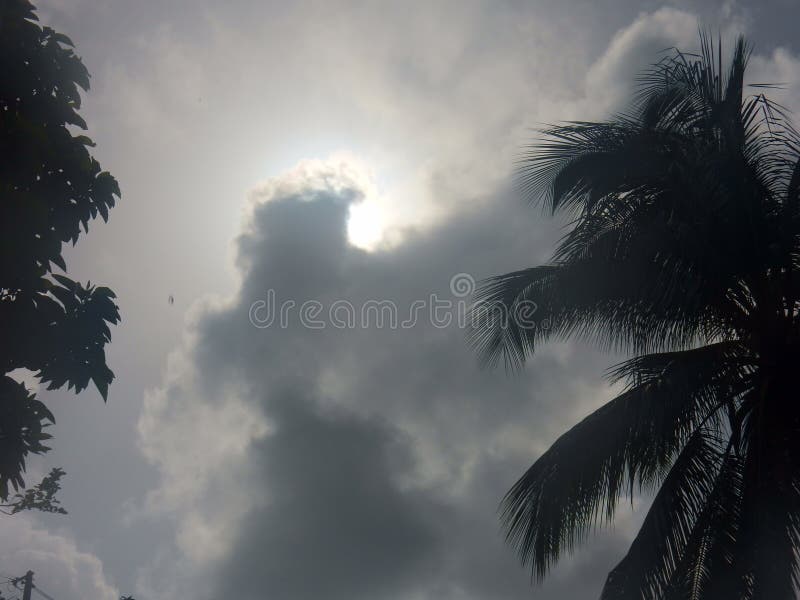 The Setting Sun Hides Behind the Clouds Stock Photo - Image of ...