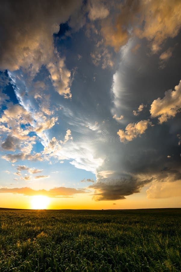 Setting Sun Lights Up a Spectacular Storm Cloud Over Beautiful Fields ...