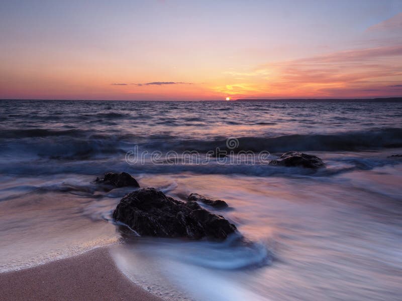 Setting sun over the sea. stock image. Image of beach - 124124117