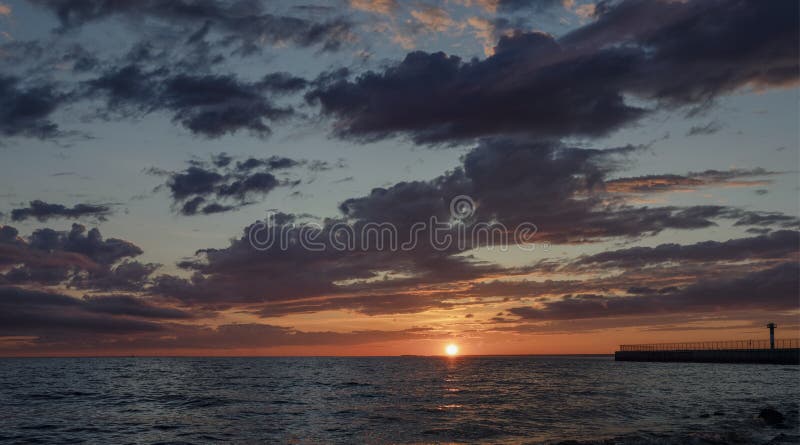 Setting sun over the sea stock image. Image of coastline - 317087229