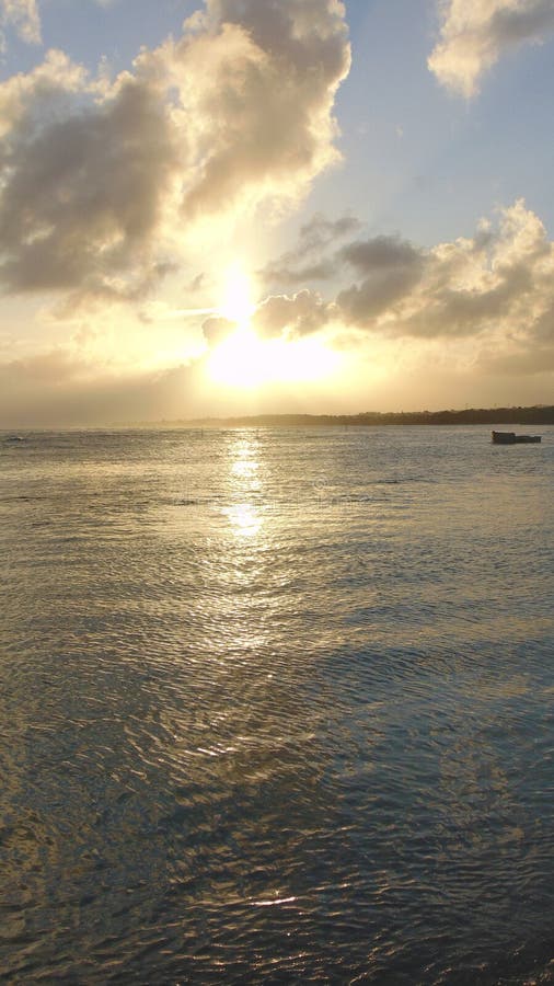 The Setting Sun Reflects on the Sea Stock Photo - Image of ocean ...