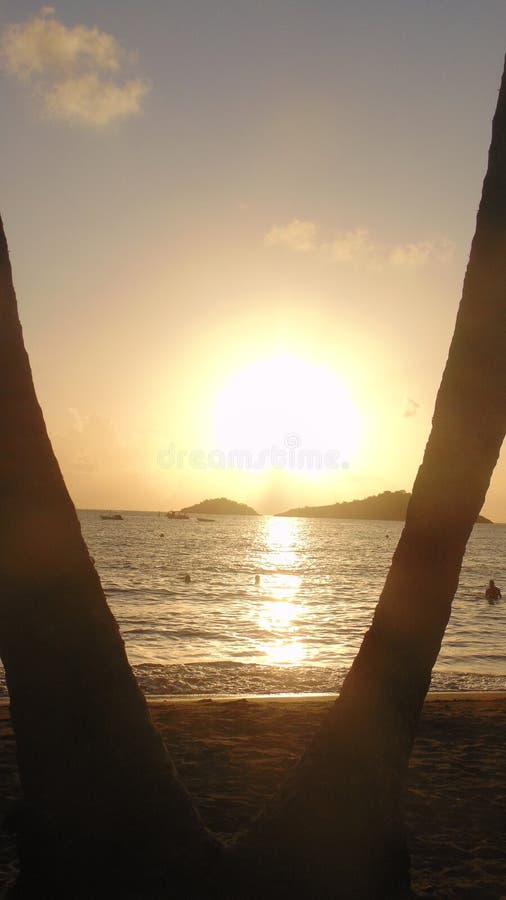 The Setting Sun Reflects on the Sea Stock Photo - Image of beach ...