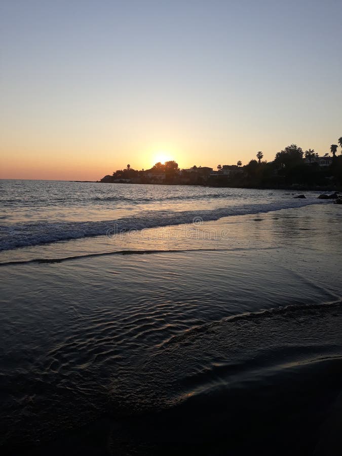 The setting sun at sea stock photo. Image of horizon - 214455572