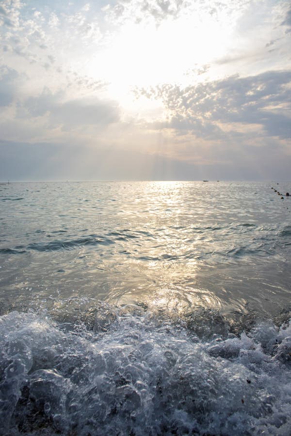 The Setting Sun is Seen through the Clouds in the Open Sea Stock Image ...