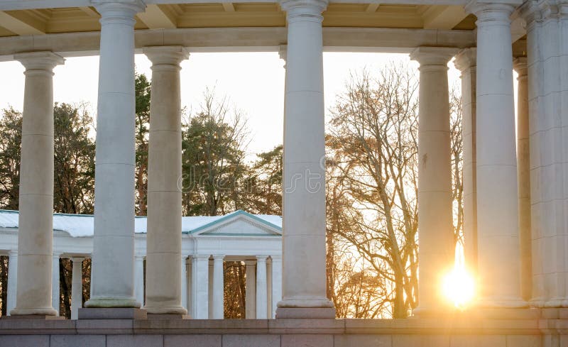 The Setting Sun Shines through the Old Columns in the Park on a Winter ...