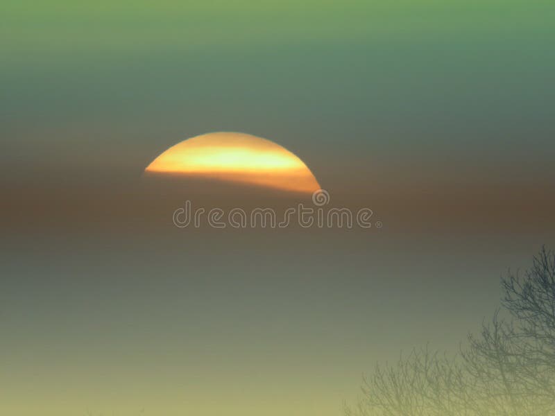 Setting Sun Sinking into a Grey Cloud Stock Image - Image of sunset ...