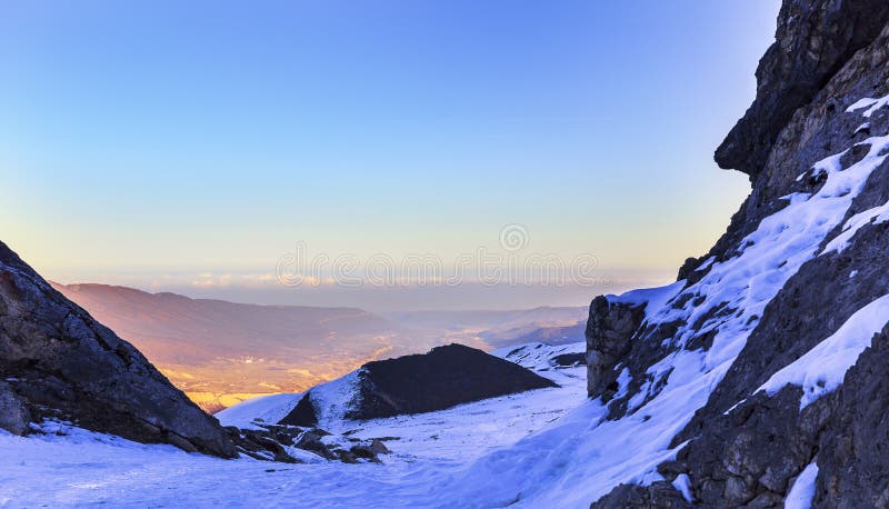 The Setting Sun in the Snow-capped Mountains Stock Image - Image of ...