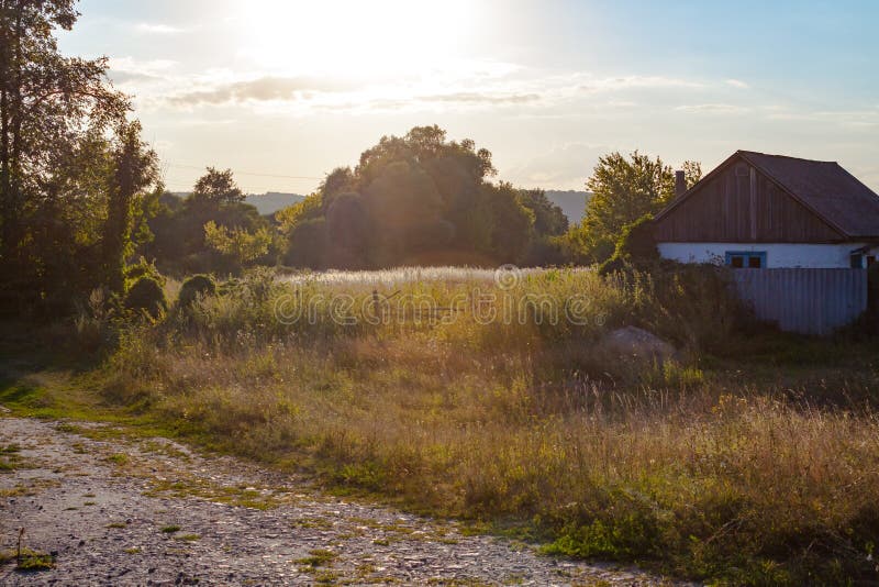 The Setting Sun in the Village. Stock Image - Image of trees, grass ...