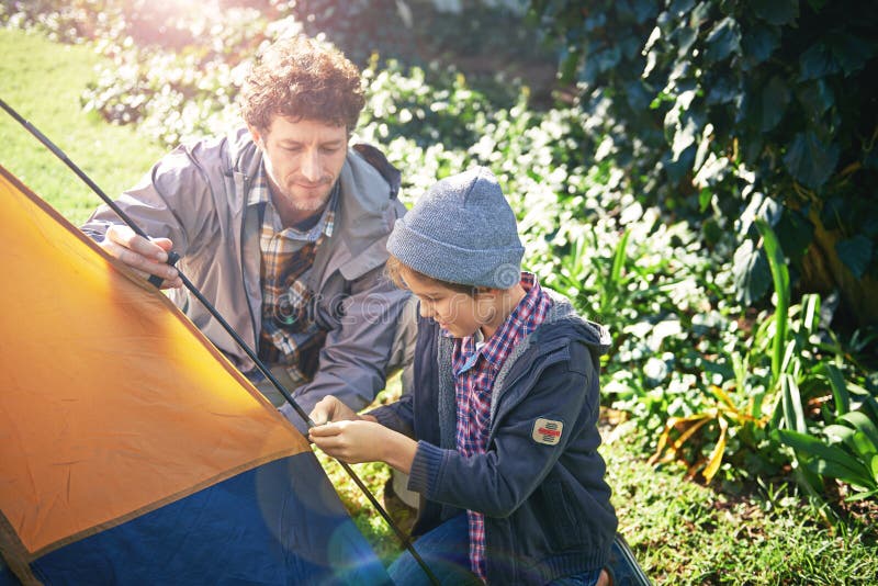 Setting Up Camp is Part of the Fun. a Father and His Young Son Putting ...