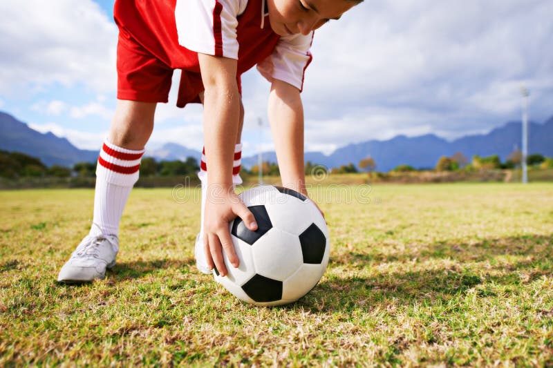Setting Up the Freekick. a Kid Setting Up a Freekick on a Soccer Field ...