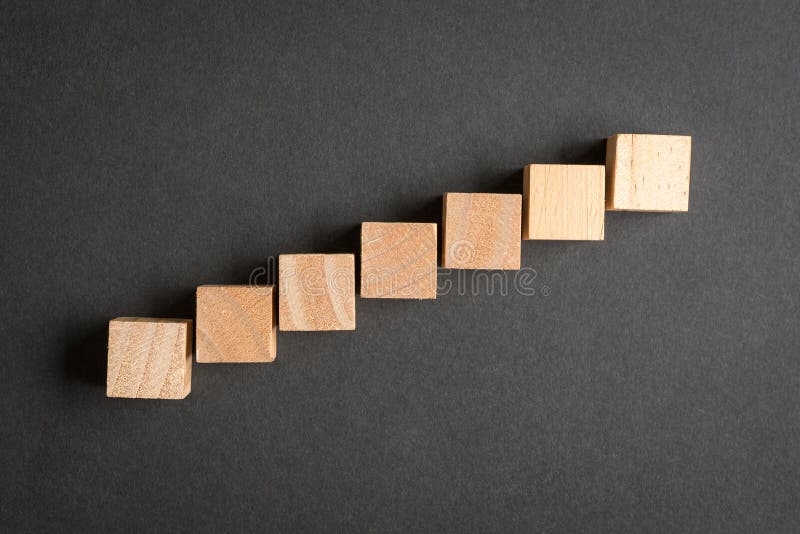 Seven Blank Square Wooden Blocks in Short Steps Up Direction on Dark ...