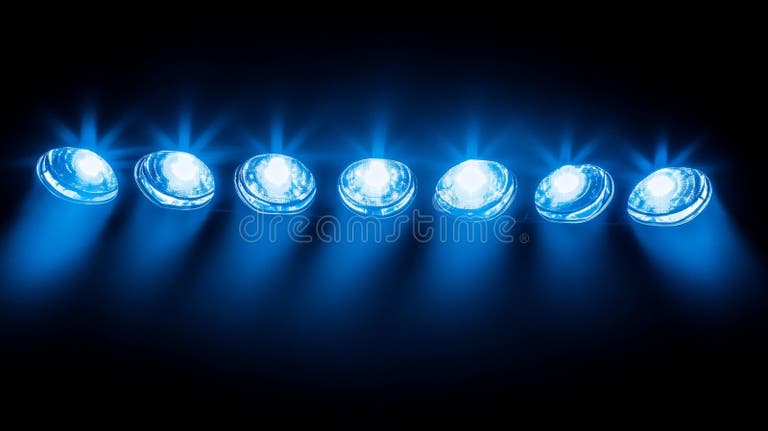 Seven Bright Blue Stadium Lights Shining on a Black Background ...
