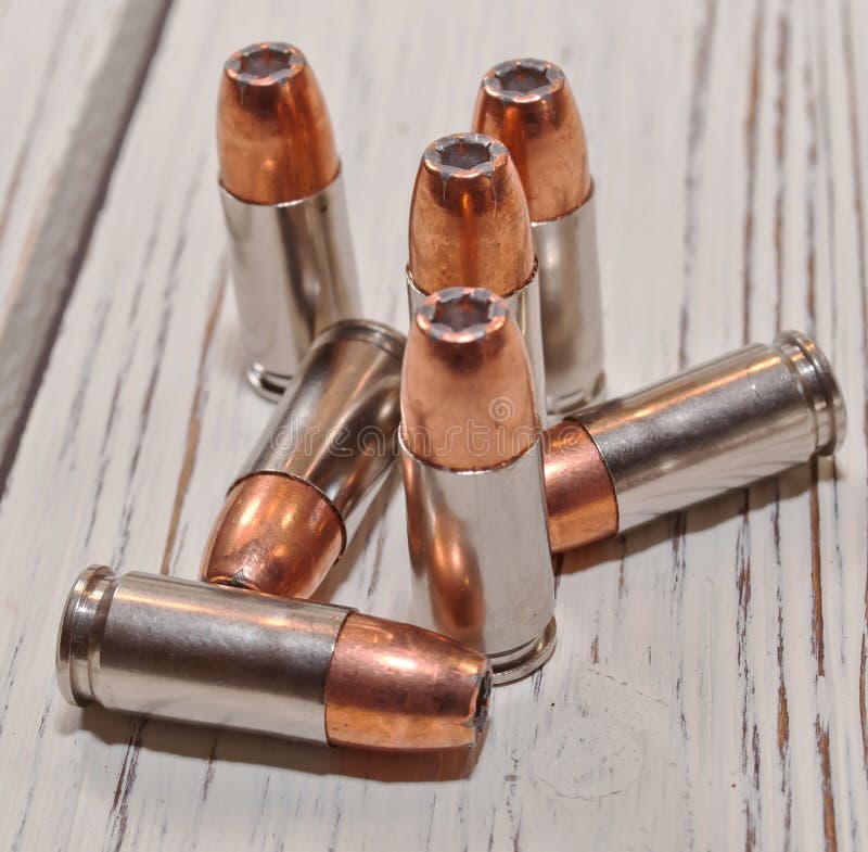 Seven Hollow Point Bullets on a Wooden Table Stock Image - Image of ...