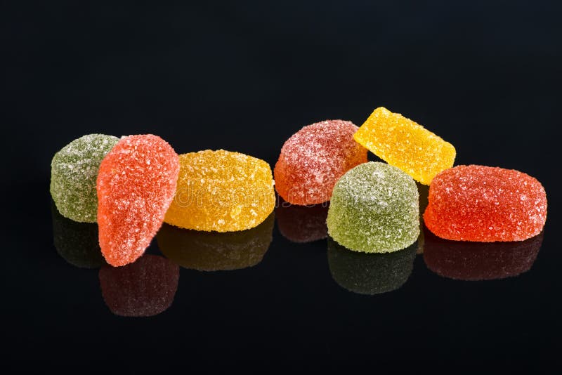 Seven Multi-colored Fruit-paste Sweets on the Black Reflecting Stock ...