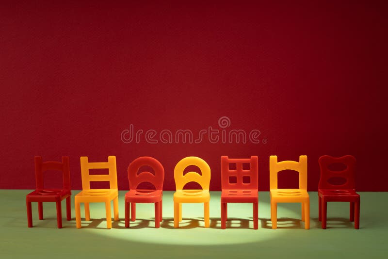Seven Plastic Chairs in Yellow and Red in One Row Stock Photo - Image ...