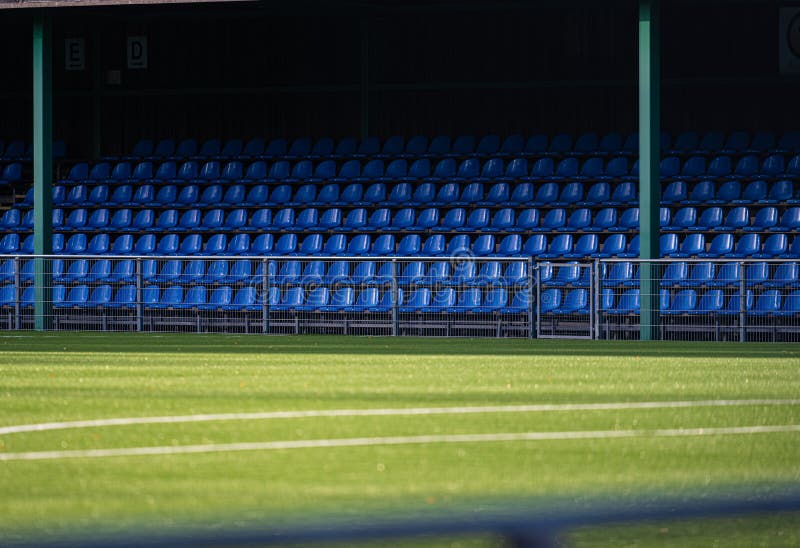 Seven Rows of Blue Seats by a Football Pitch.. Stock Image - Image of ...